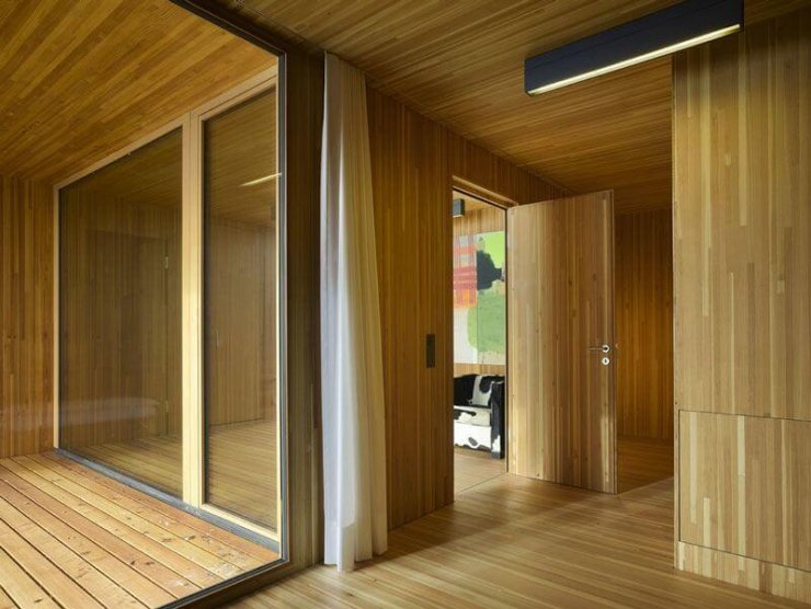 This wooden house in Switzerland sits inside a concrete box